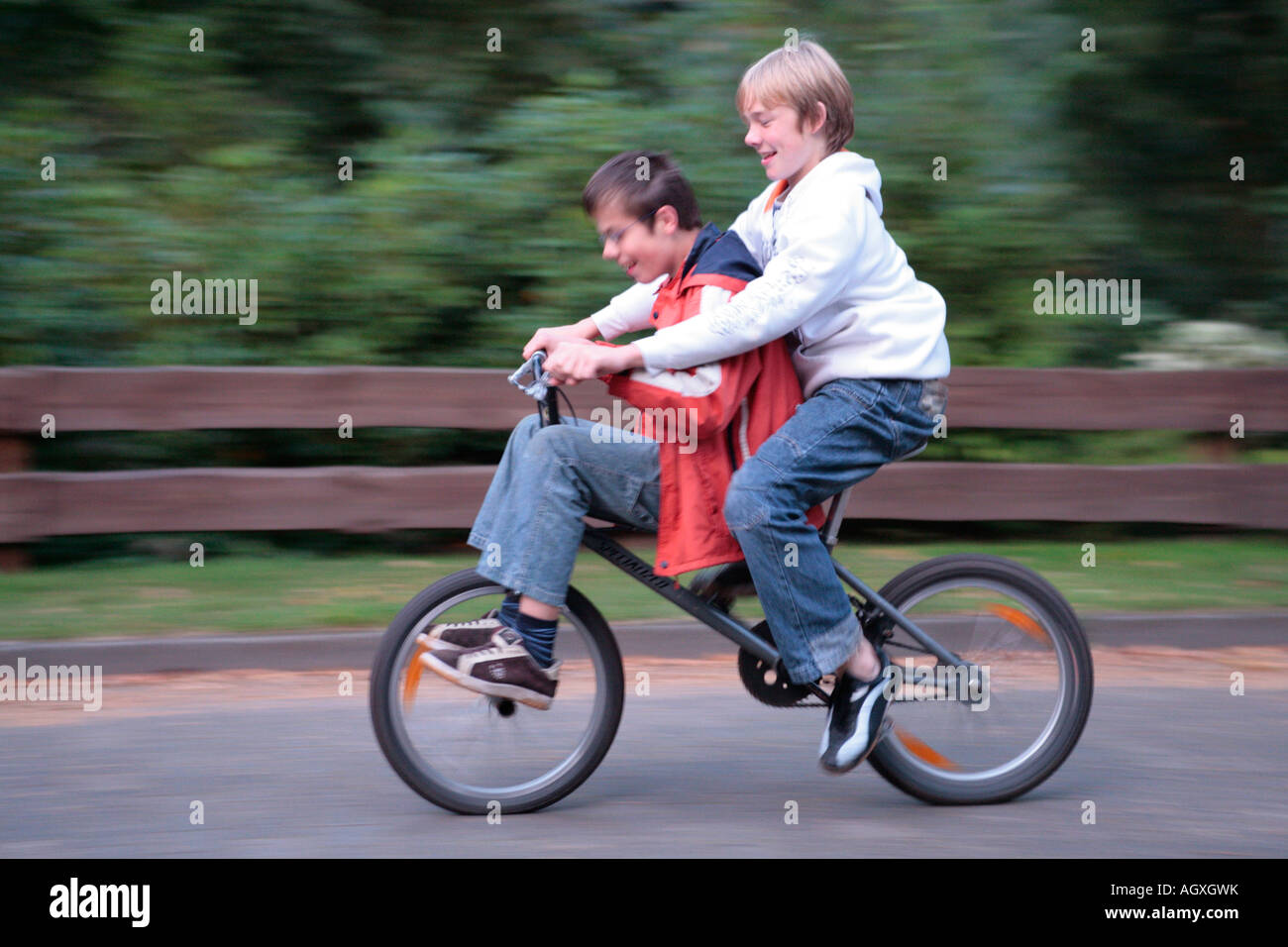 two young boys together on a bmx bike Stock Photo - Alamy