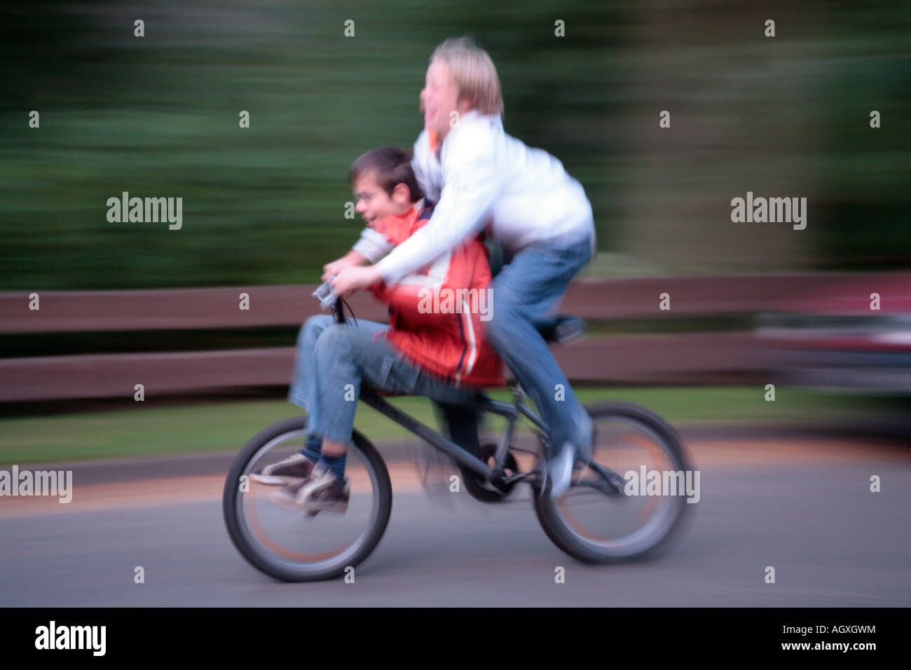 two young boys together on a bmx bike Stock Photo - Alamy