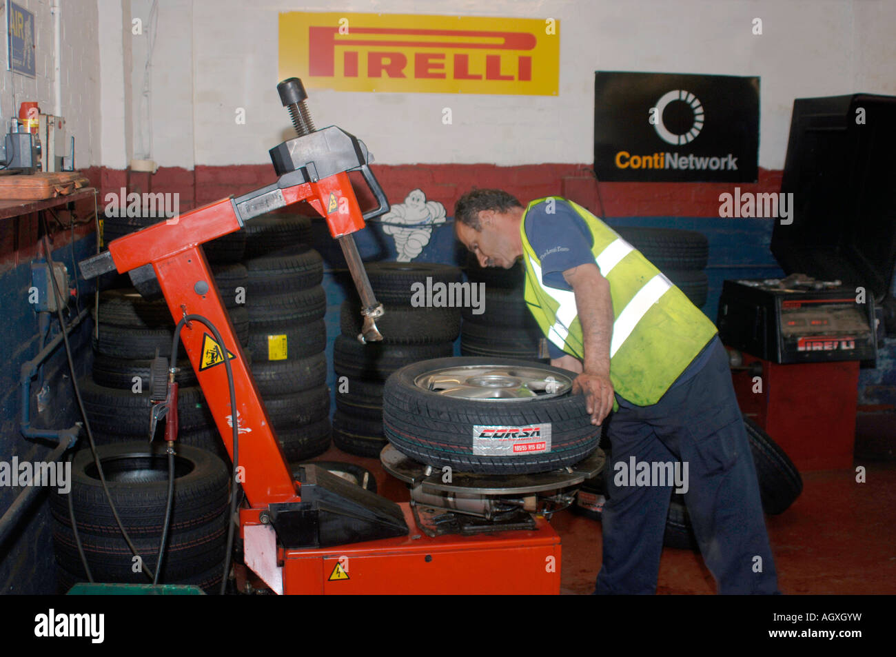 Man fitting new tyre hi-res stock photography and images - Alamy
