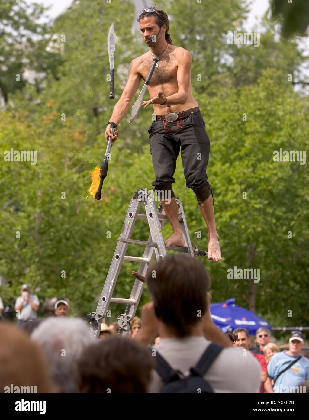 Street performer juggling on a ladder Stock Photo - Alamy