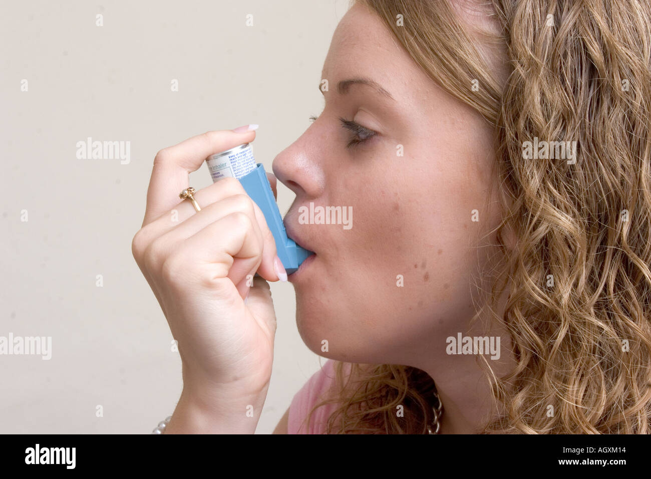 Pretty blond teenager using asthma Ventolin inhaler Stock Photo - Alamy