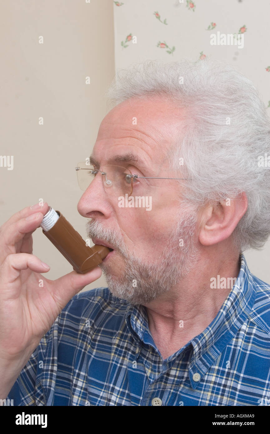 Older man using Becotide asthma preventer inhaler Stock Photo - Alamy