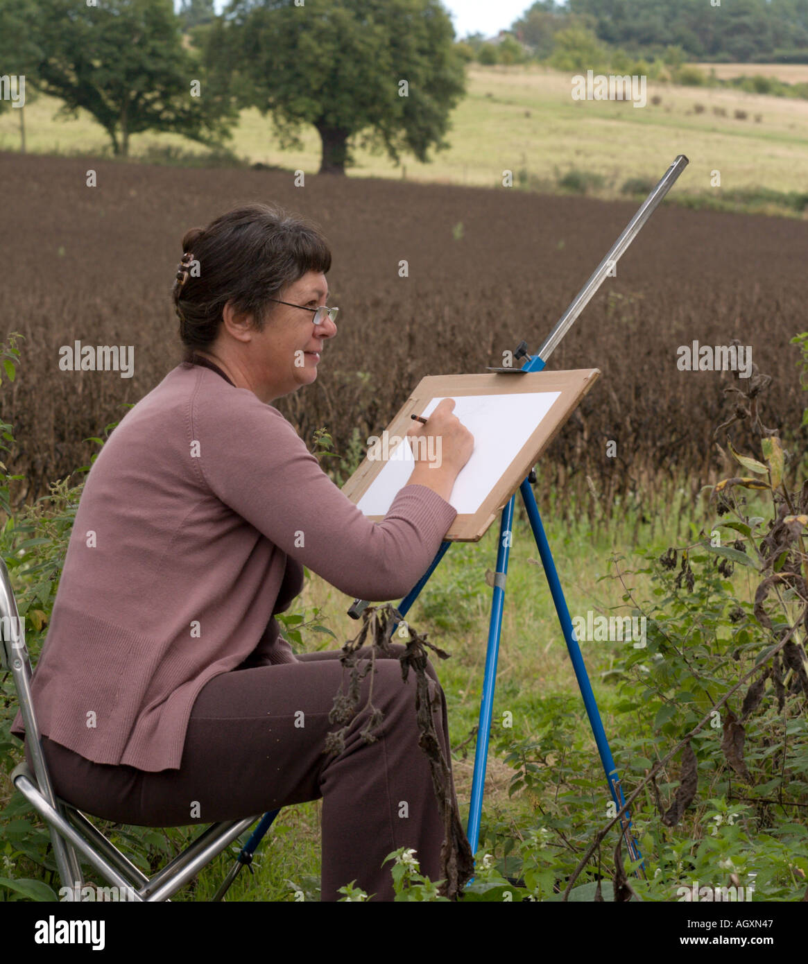 A female painter artist at Historic Flatford in Suffolk England Stock ...