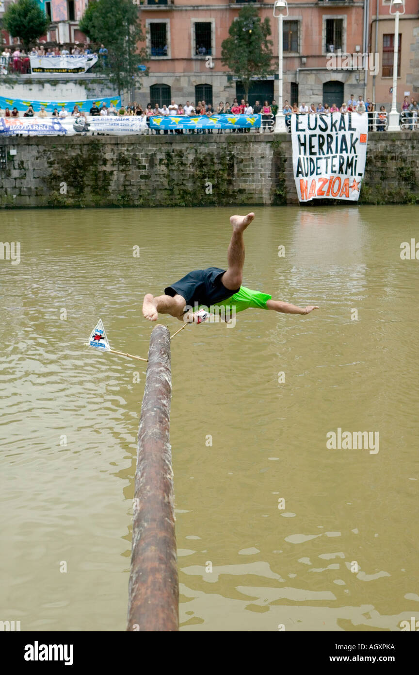 Man falling off greasy pole into river Bilbao Pais Vasco Basque Country ...