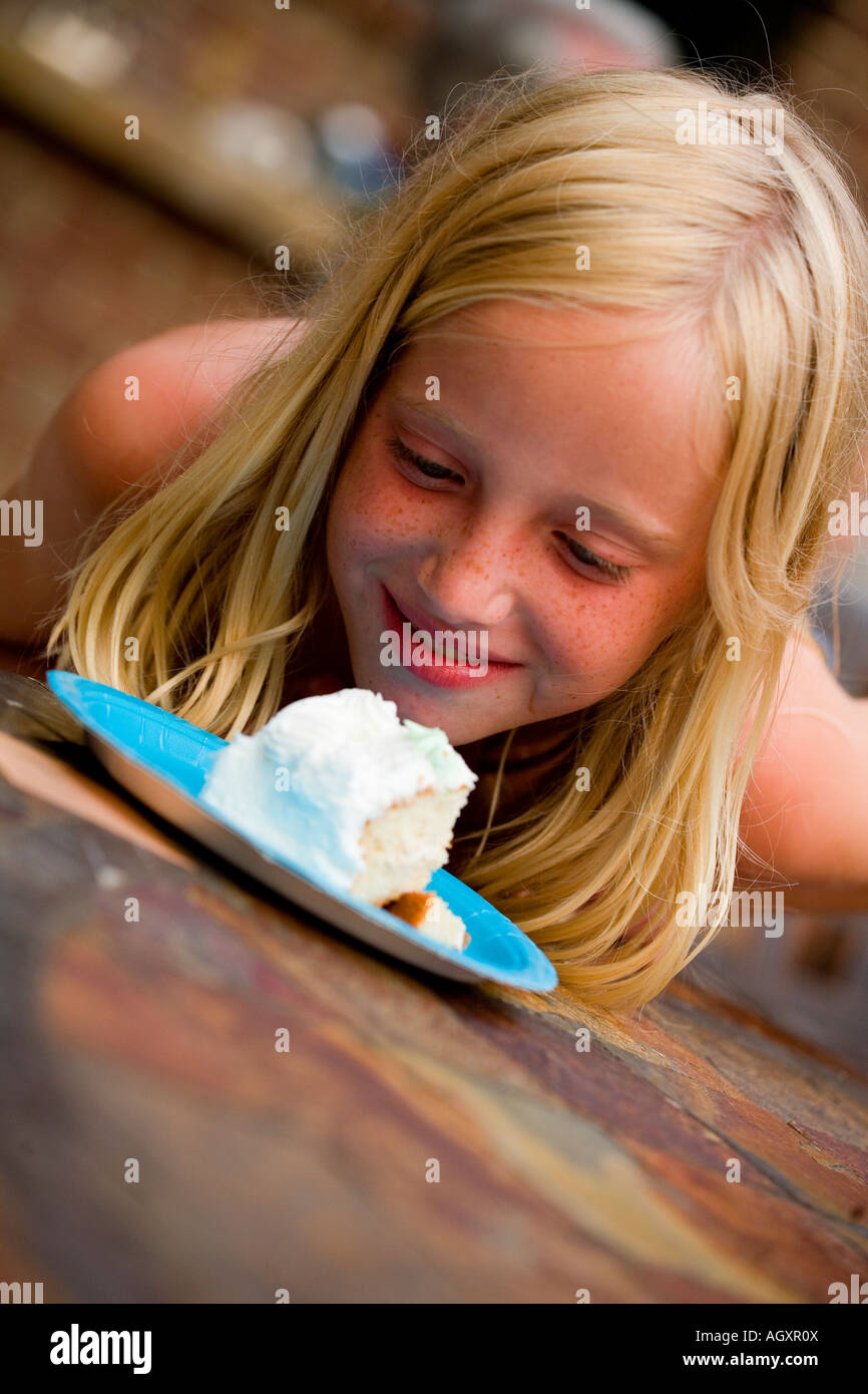 Young girl eating a cake at a birthday party Stock Photo - Alamy