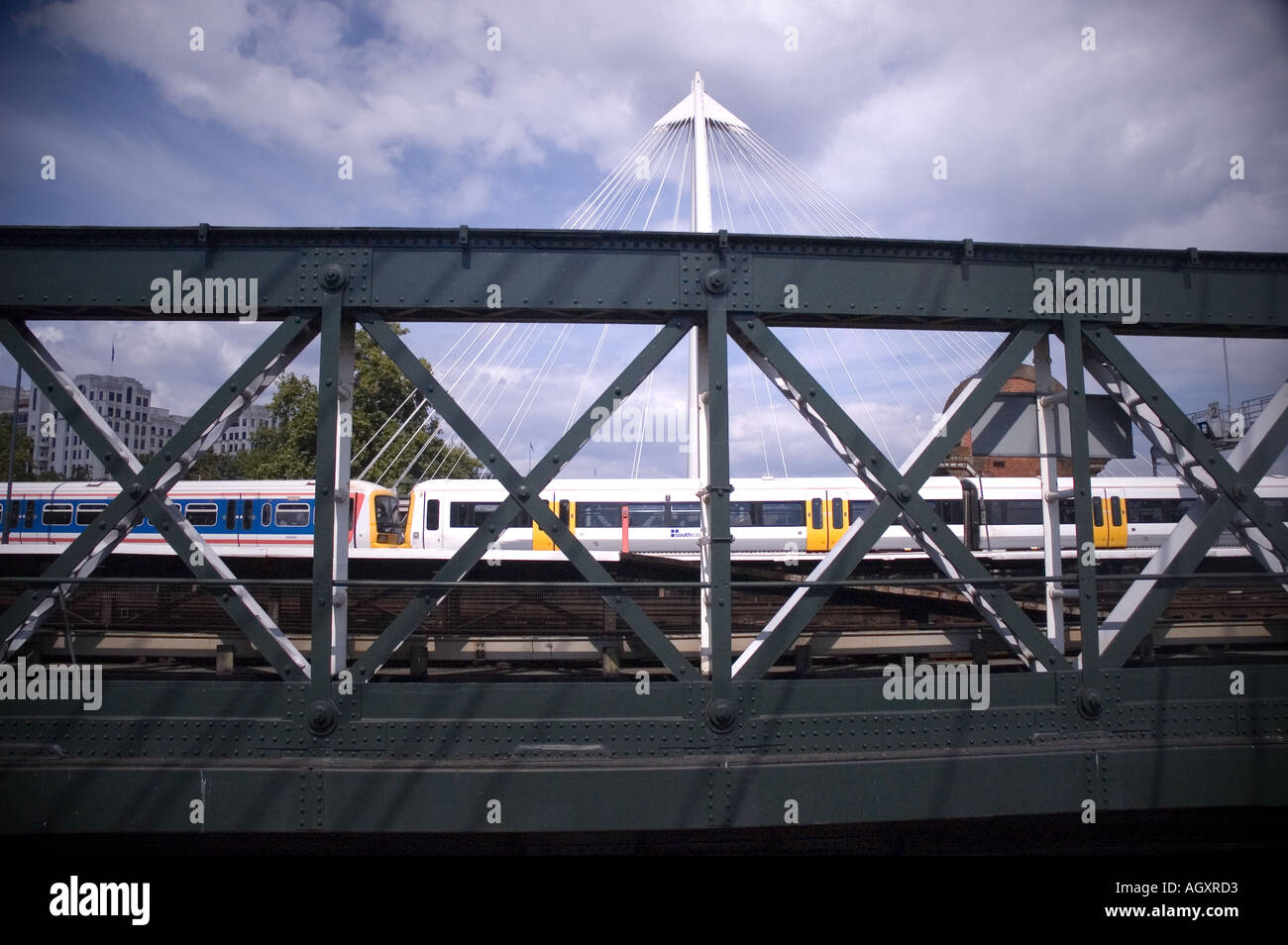 Train moving on a bridge, Golden Jubilee Bridges, Thames River, London ...