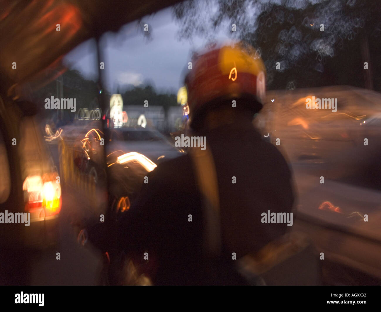 Blurred view of city traffic from inside an auto rickshaw at night a ...