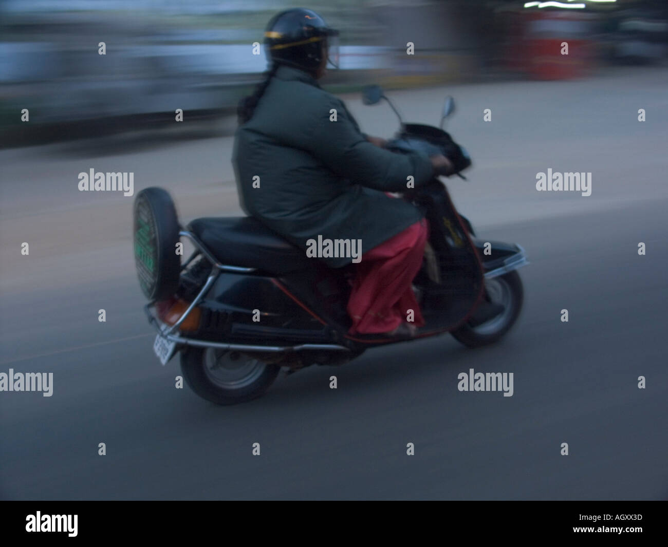 Scooter rider on streets Stock Photo - Alamy