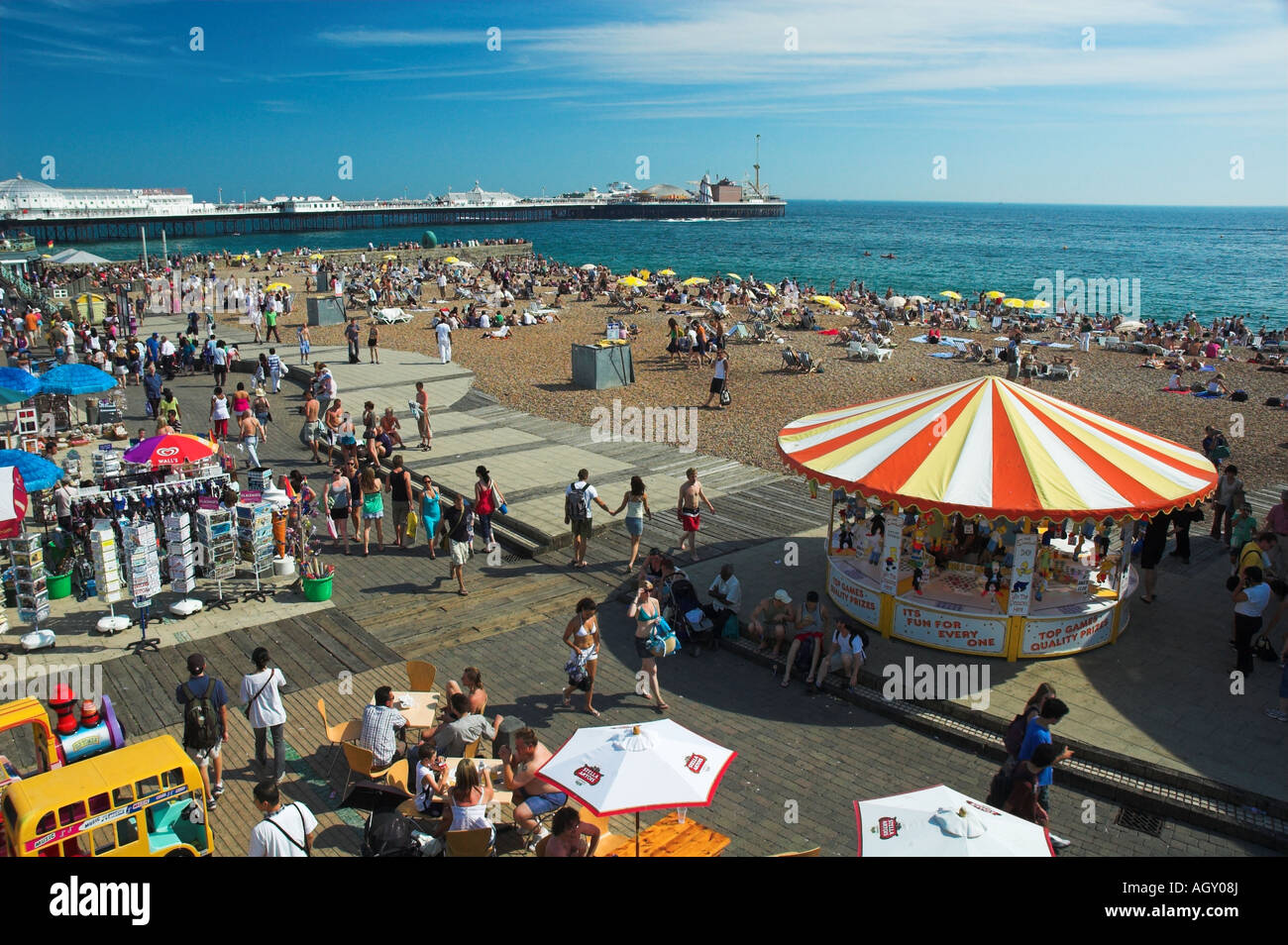 Brighton foreshore on a summer's day with fairground rides in ...