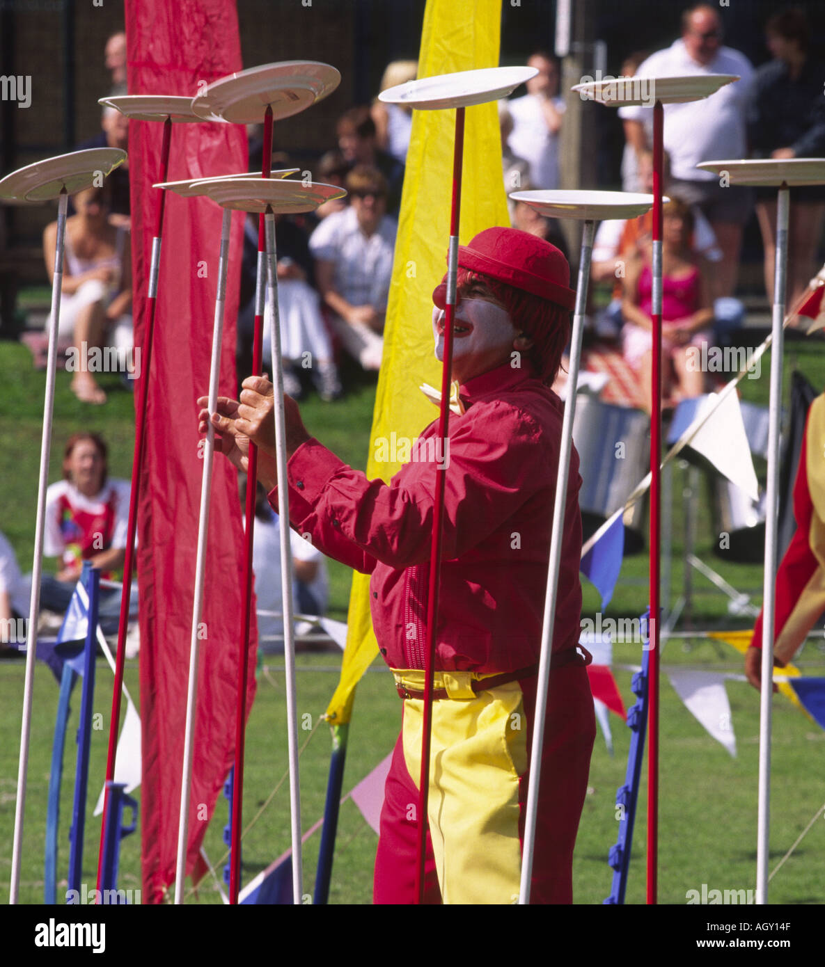 Red and yellow clown balancing plates at Sanquhar Riding of the Marches ...