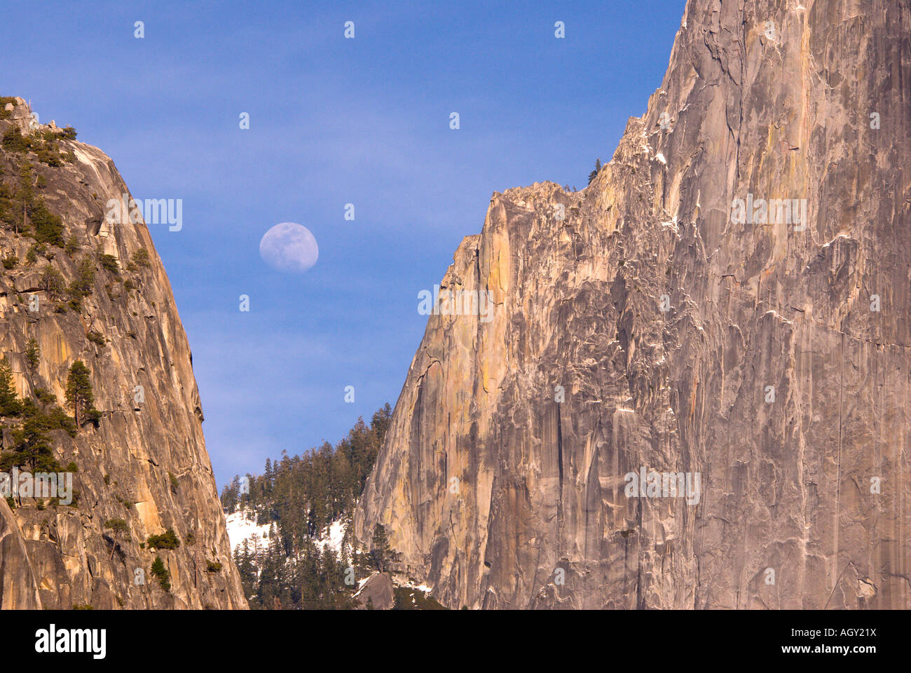 Yosemite National park full moon rising between two granite rocks, half ...