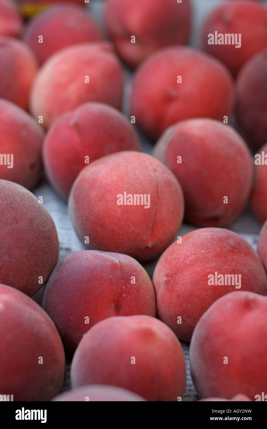 Red peaches on newspaper Stock Photo - Alamy
