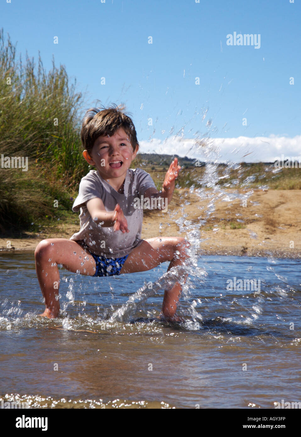 Boy splashing water Stock Photo - Alamy