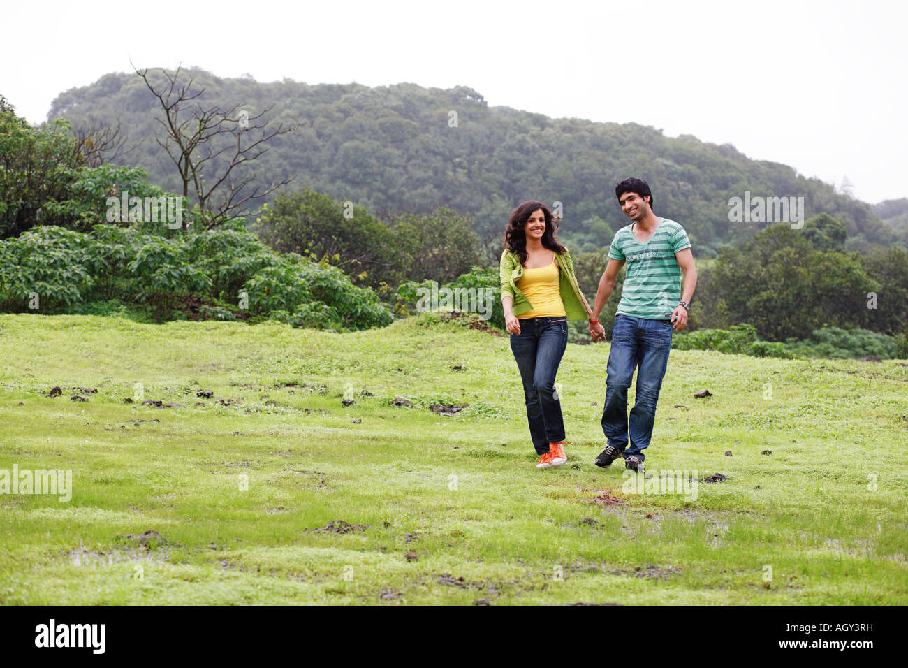 Couple holding hands and walking Stock Photo - Alamy