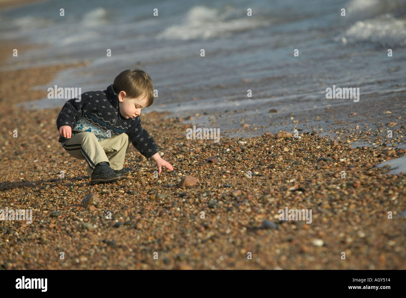 Boy Throwing Pebbles Into The Sea High Resolution Stock Photography and ...