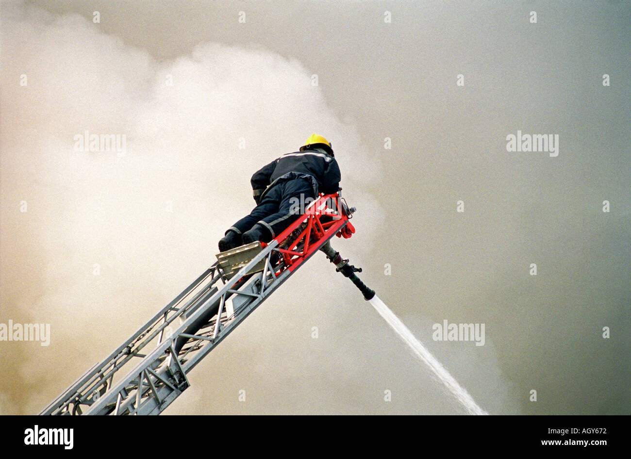 Firefighter in action at the top of a hydraulic ladder, Britain UK ...