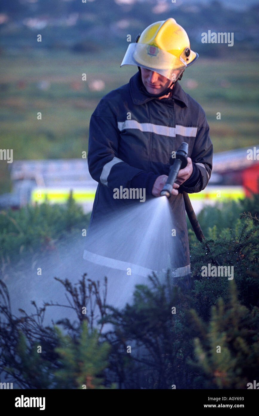 Firefighters using hose reel jet hi-res stock photography and images ...