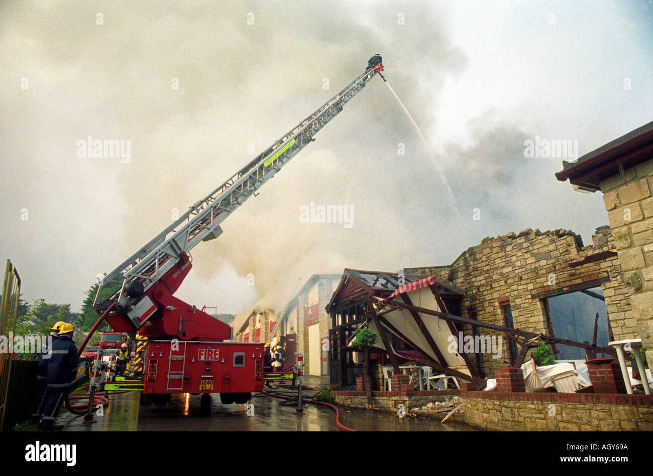 Firefighter in action at the top of a hydraulic ladder, Britain UK ...