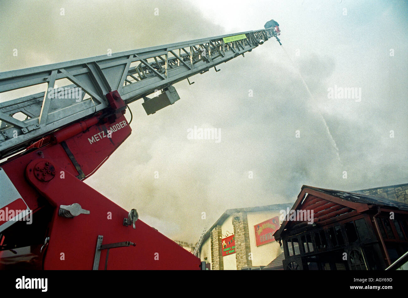 Firefighter in action at the top of a hydraulic ladder, Britain UK ...