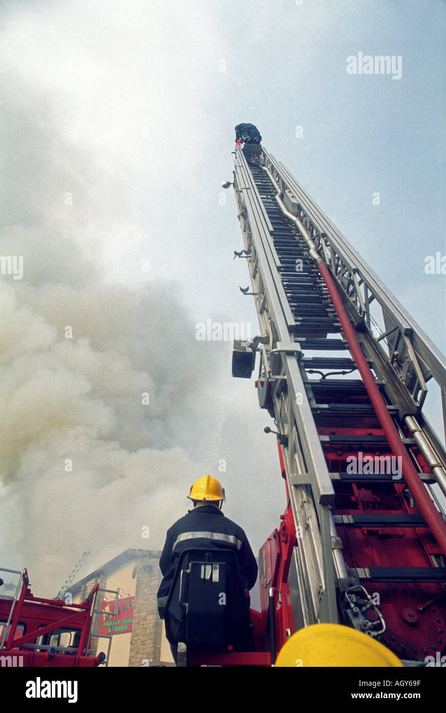 Firefighter in action at the top of a hydraulic ladder, Britain UK ...