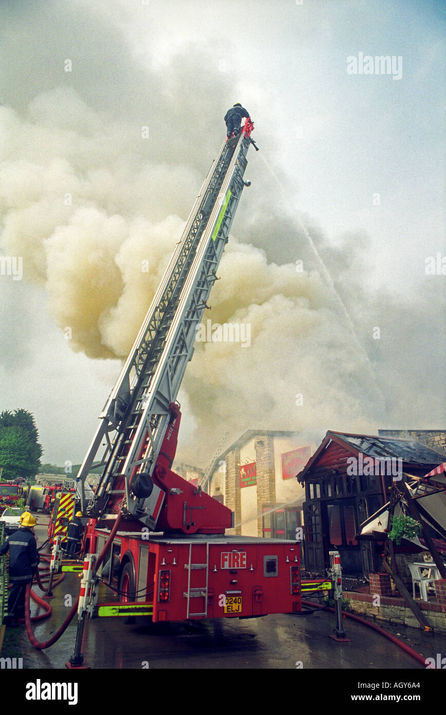 Firefighter in action at the top of a hydraulic ladder, Britain UK ...
