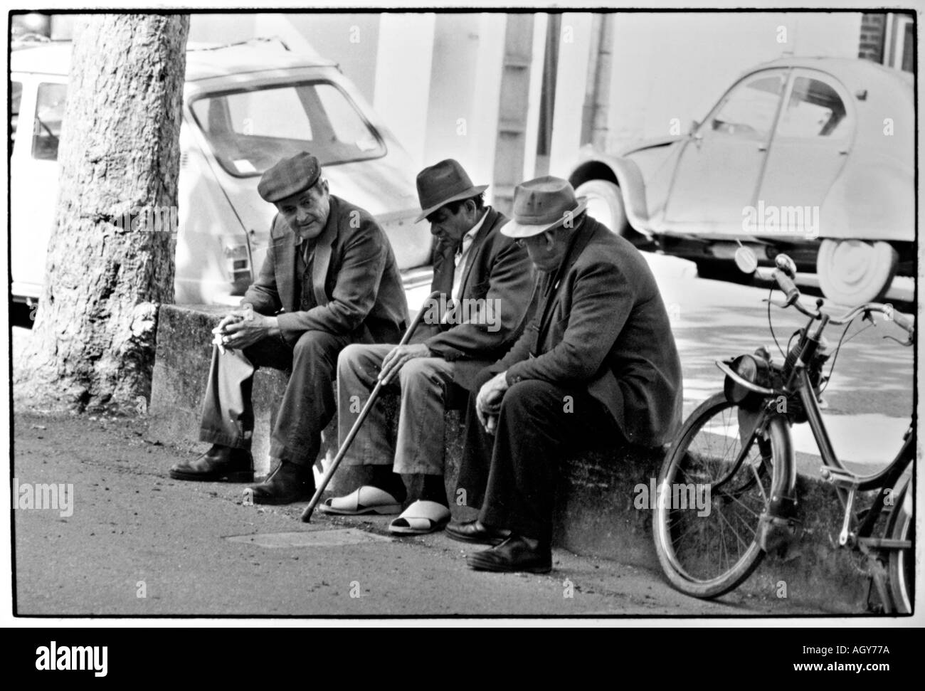 street photography old men sitting on a bench at the street in southern ...