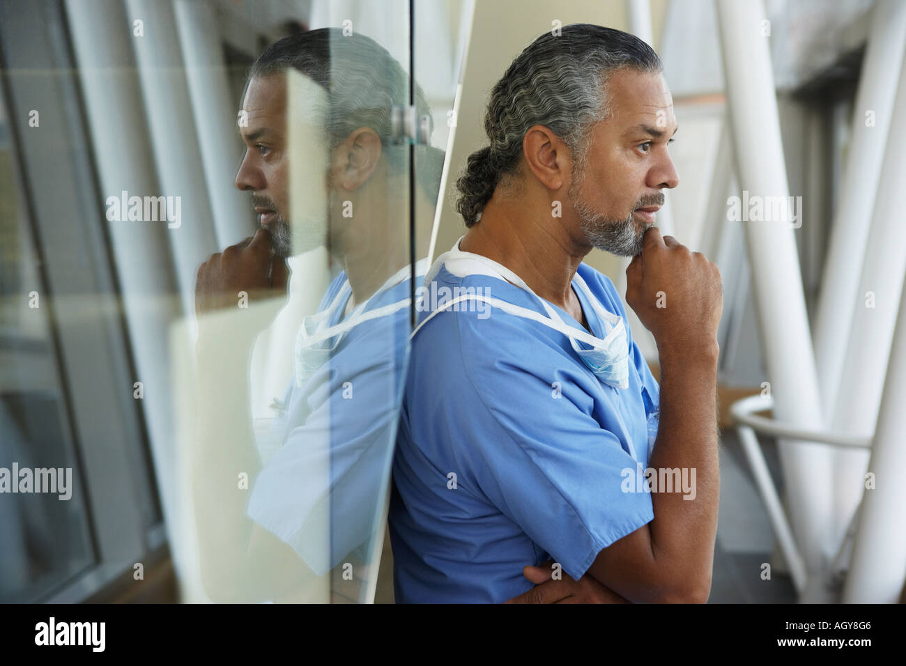 Middle aged male African surgeon thinking Stock Photo - Alamy