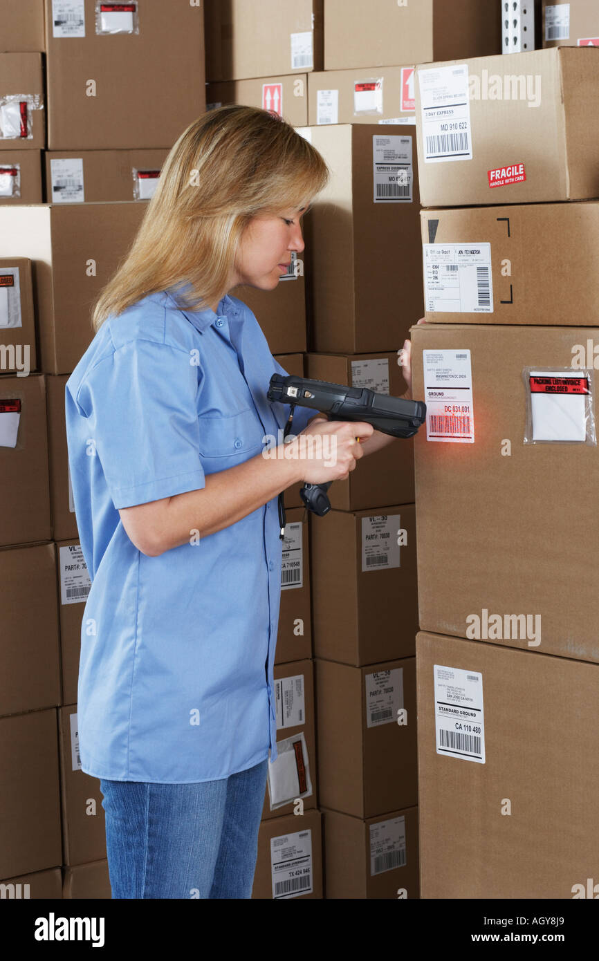 Female warehouse worker scanning package Stock Photo - Alamy
