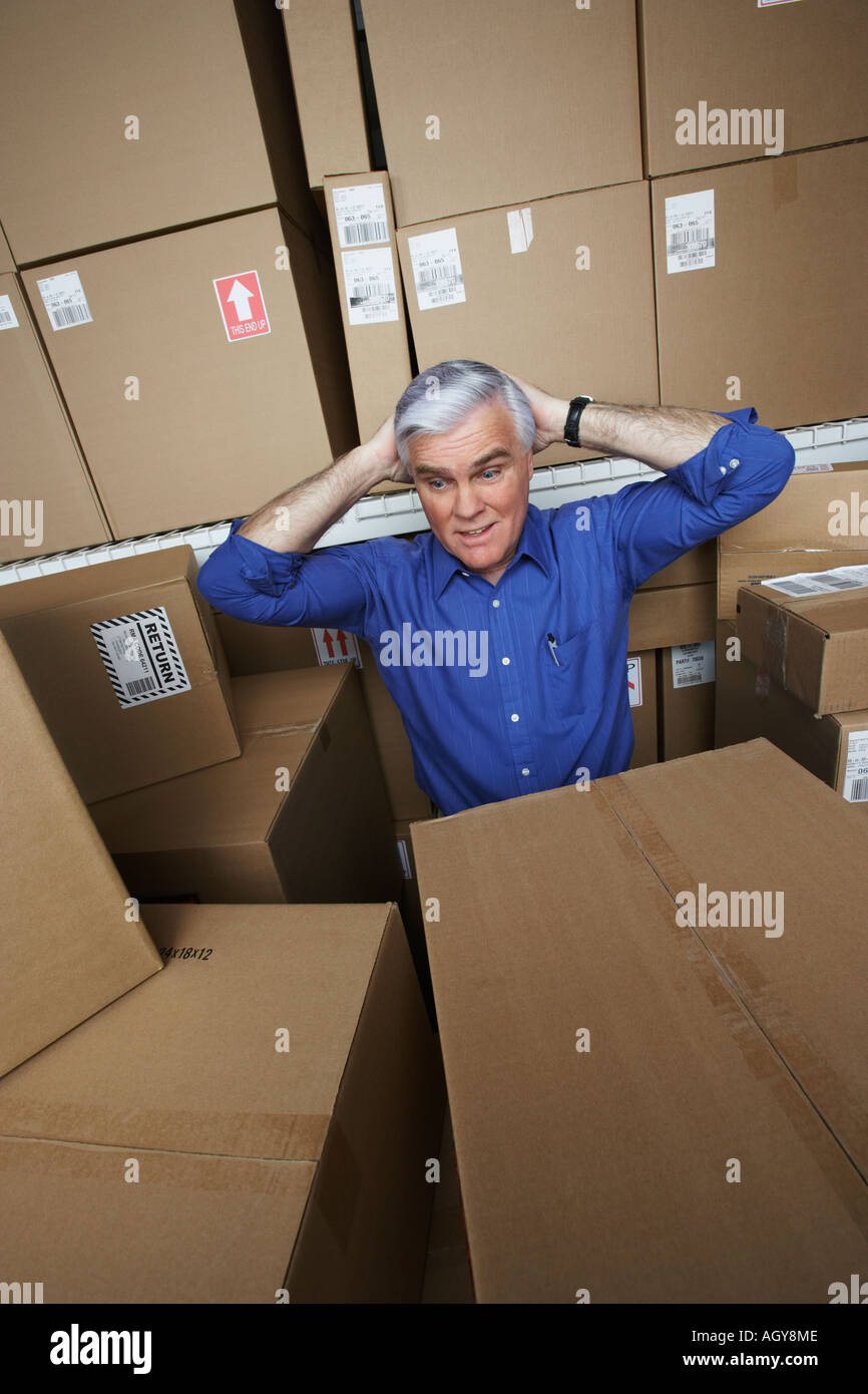 Frustrated businessman in warehouse Stock Photo - Alamy