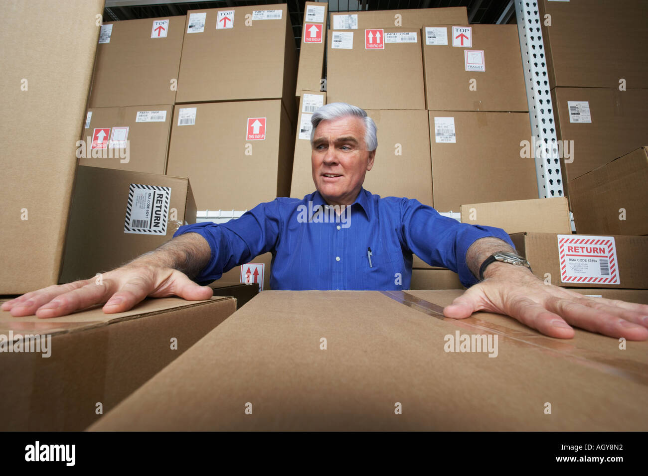 Frustrated businessman in warehouse Stock Photo - Alamy