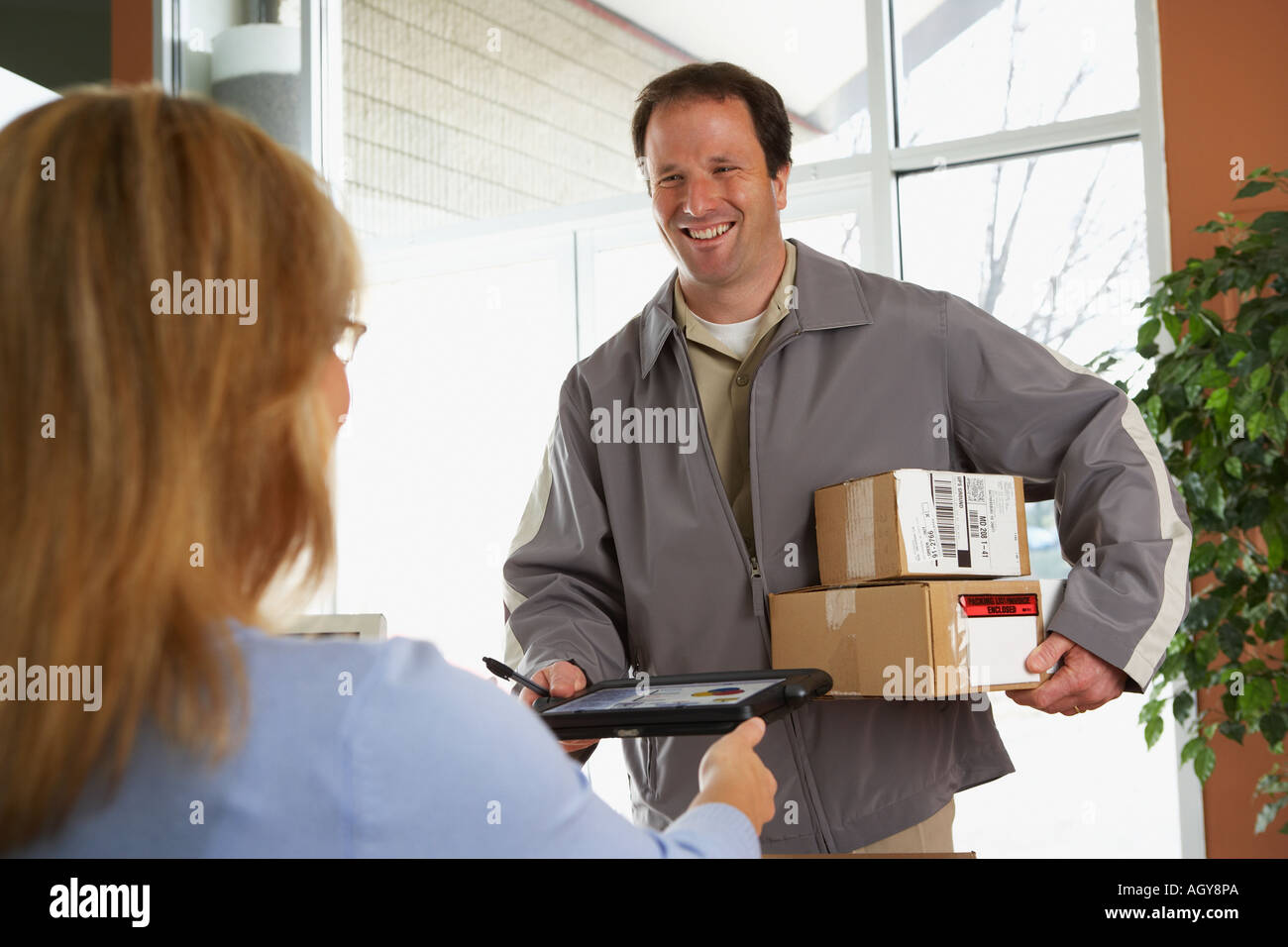 The person distributing the packages hi-res stock photography and ...