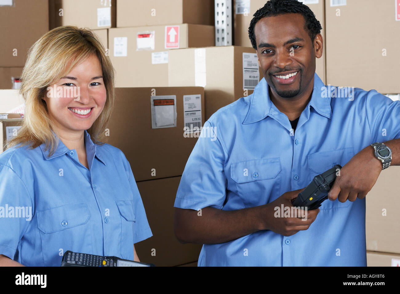 Male and female warehouse workers in warehouse Stock Photo - Alamy