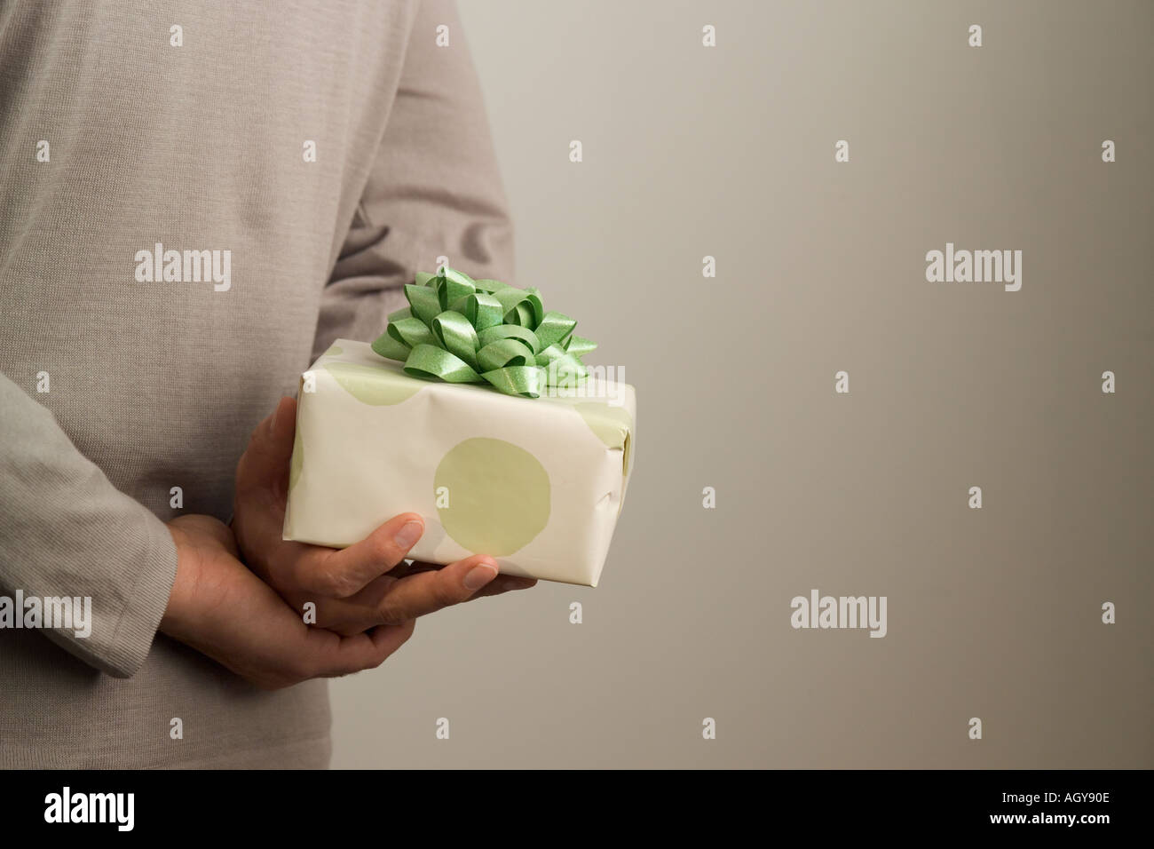 Man hiding a gift hi-res stock photography and images - Alamy