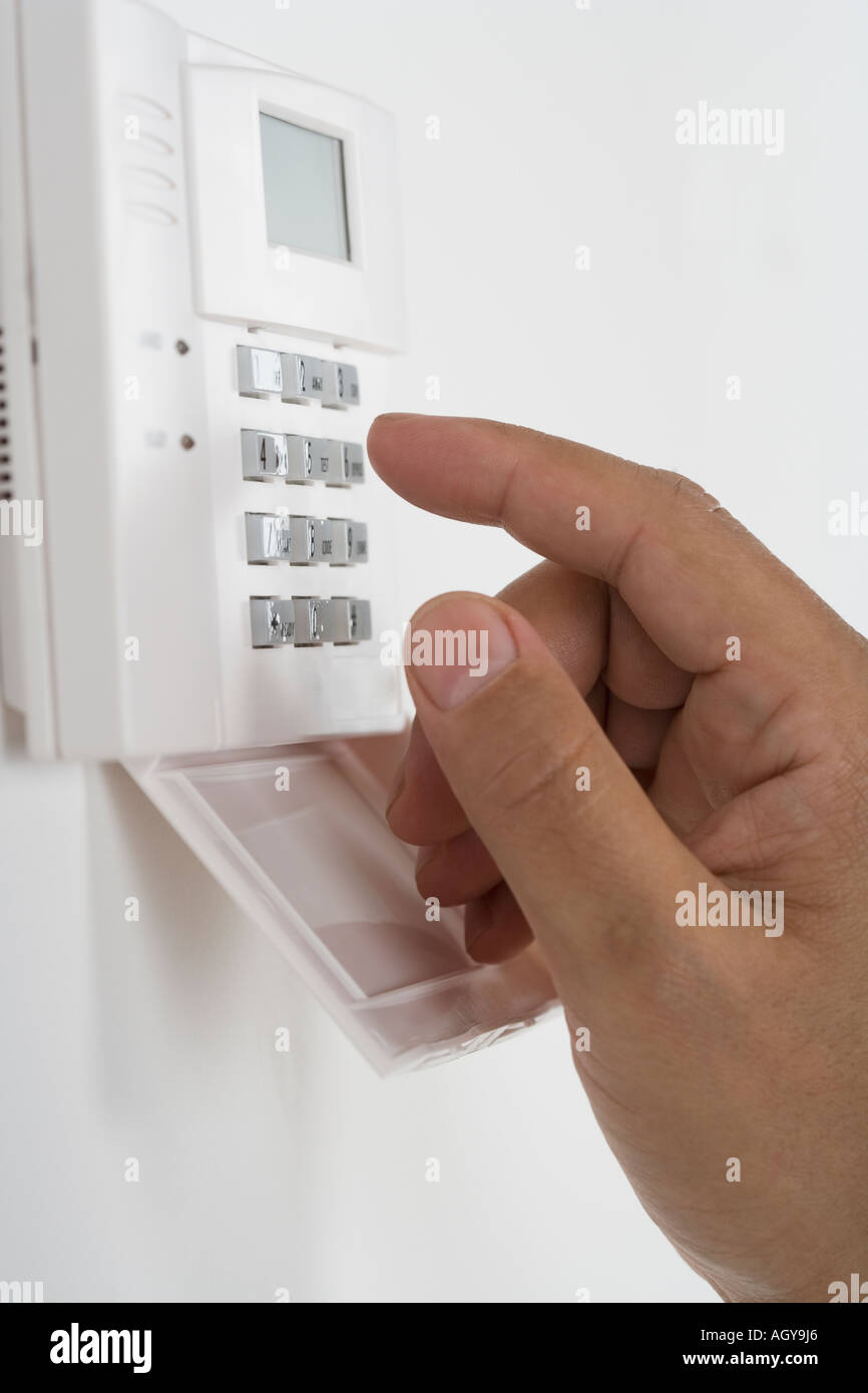 Close of African male hand using keypad Stock Photo - Alamy