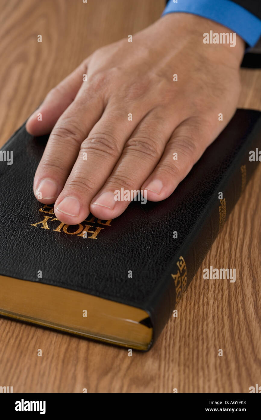 Hand on bible hi-res stock photography and images - Alamy