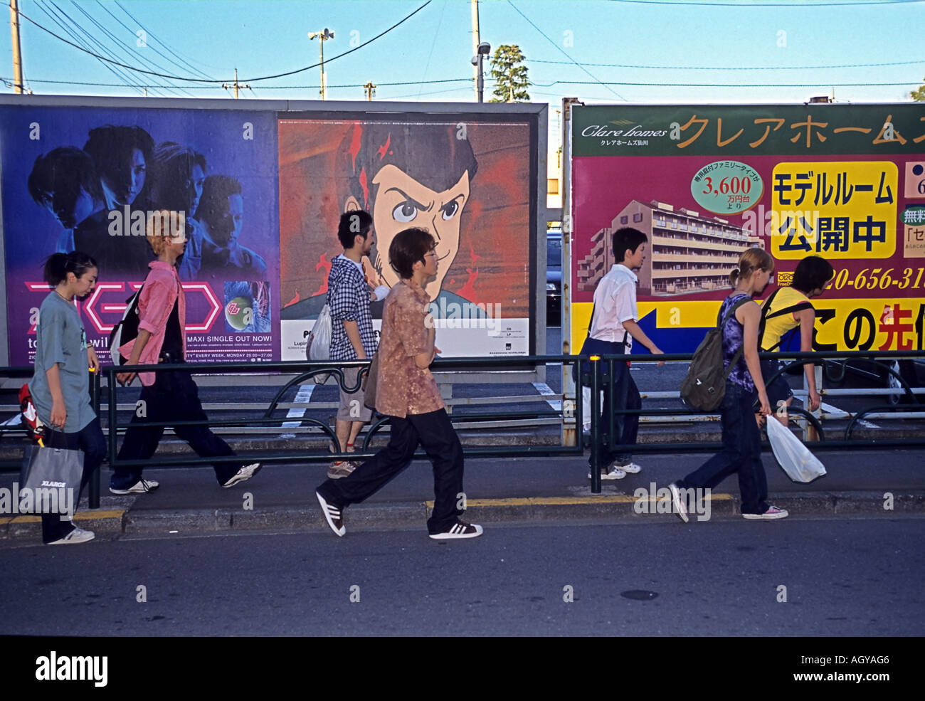 Pedestrians in a street of Tokyo with adverts in the background Stock ...