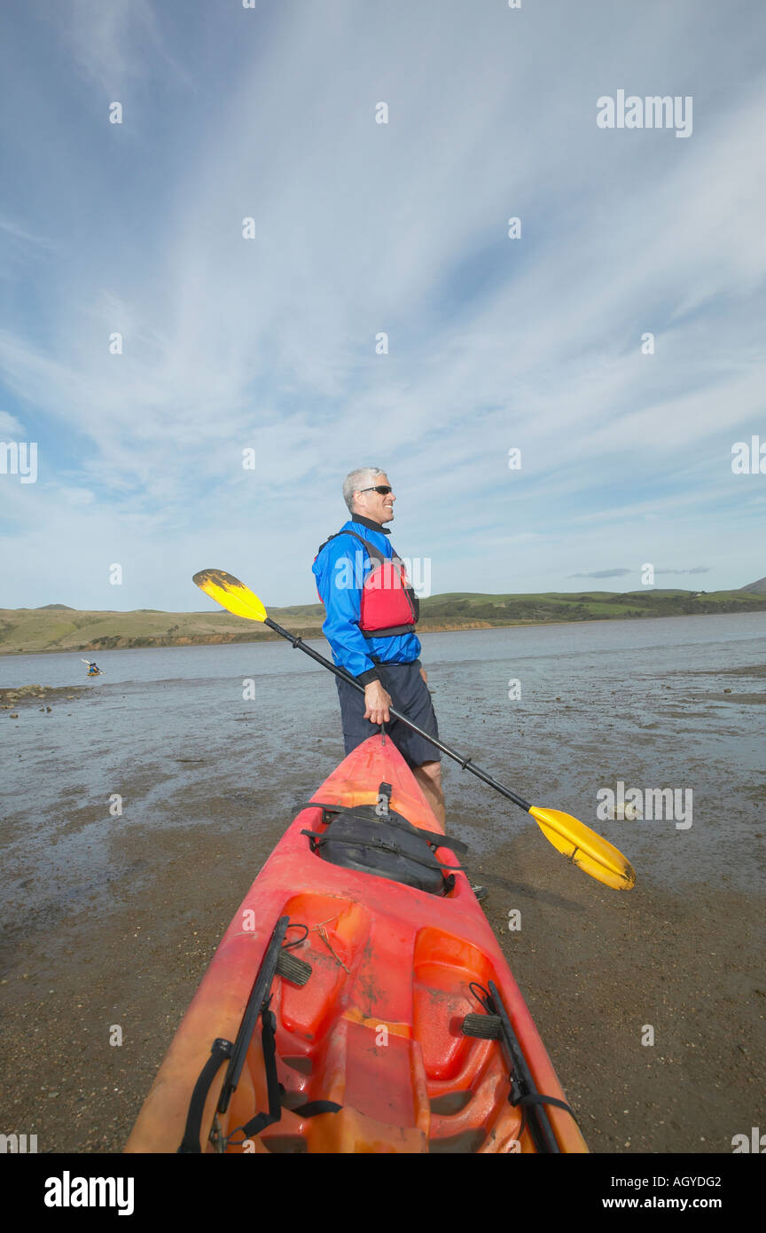 Middle aged man holding kayak and paddle California United States Stock ...