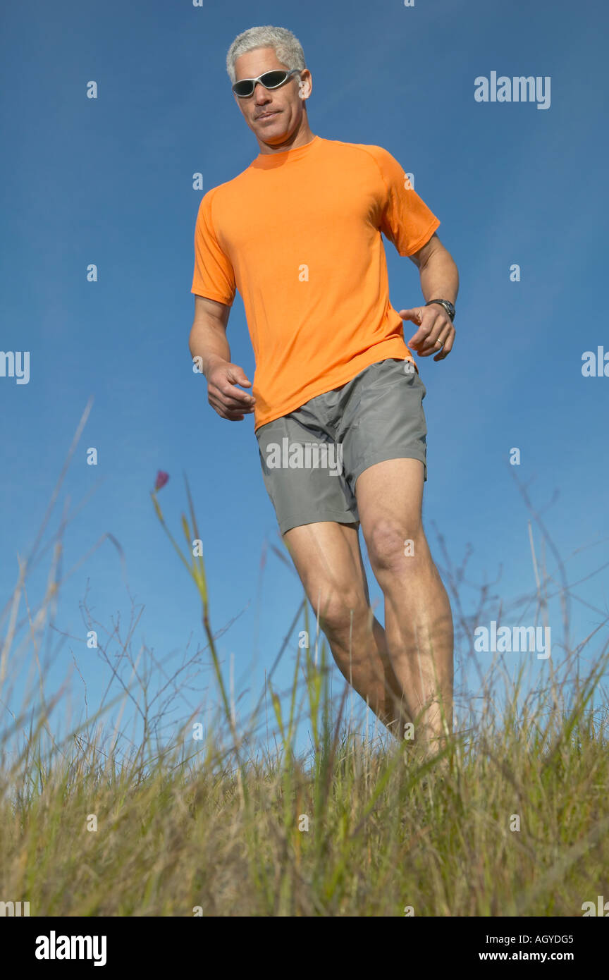 Middle aged man walking through grass California United States Stock ...