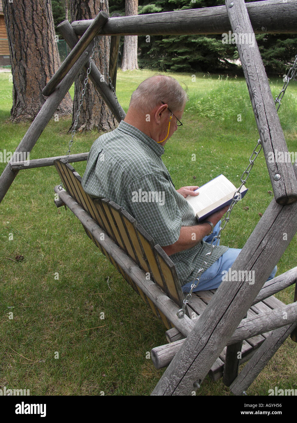 Reading on Bench Swing Stock Photo - Alamy