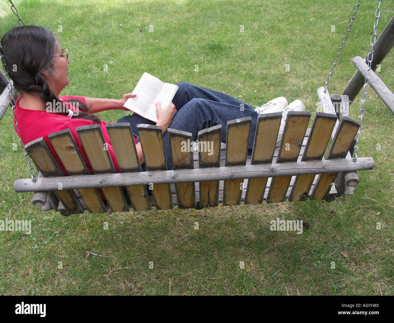 Reading on Bench Swing Stock Photo - Alamy