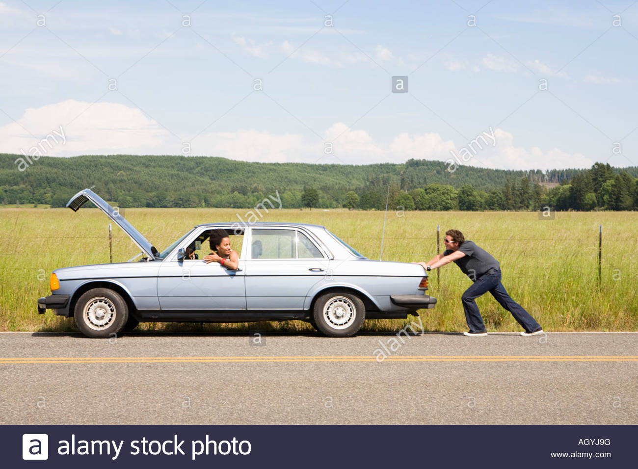 Man pushing broken down car Stock Photo: 14309451 - Alamy