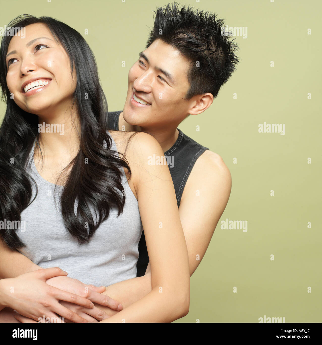 Studio shot of young Asian couple hugging Stock Photo - Alamy