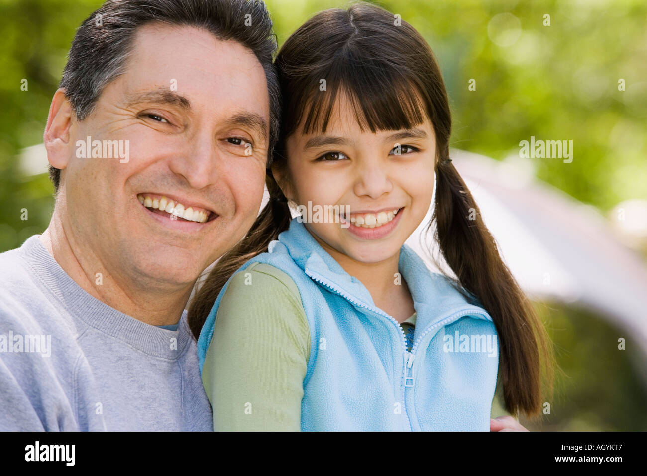 Hispanic father and daughter smiling Stock Photo - Alamy