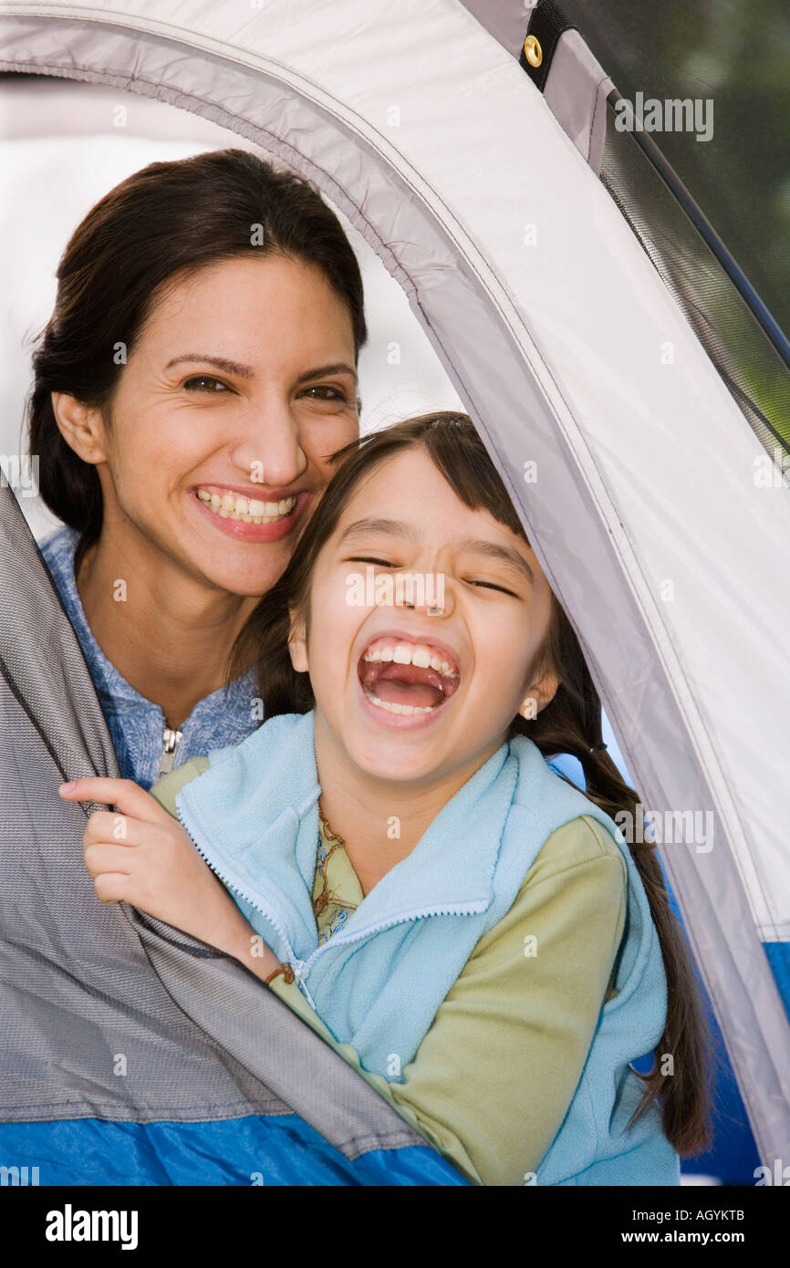 Hispanic mother and daughter laughing in tent Stock Photo - Alamy