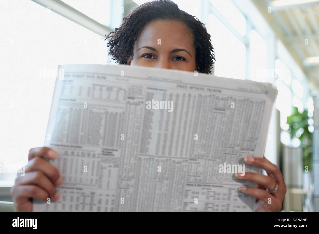 African American woman reading newspaper Stock Photo - Alamy
