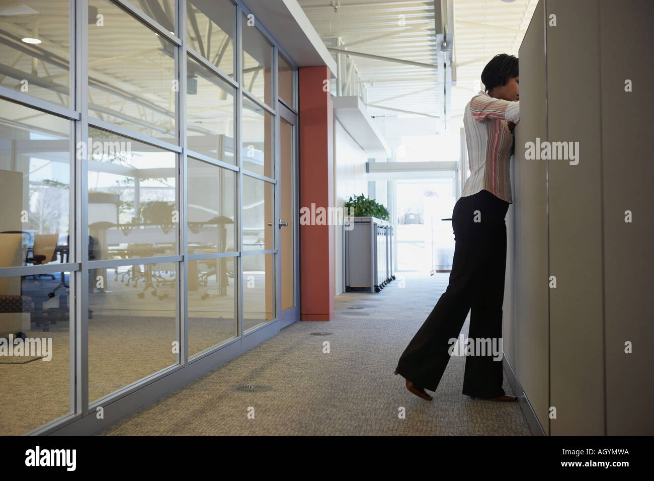 African American businesswoman leaning over cubicle wall Stock Photo ...