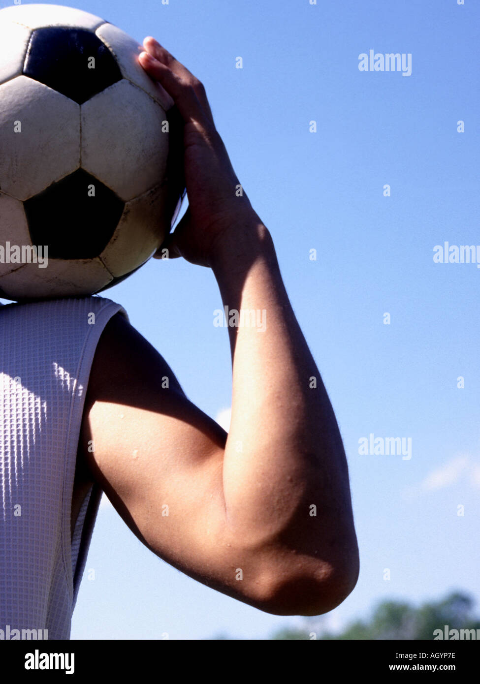Low angle view of a person holding a soccer ball on his shoulders Stock ...