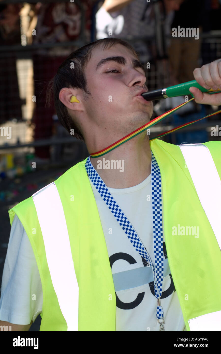 Carnival goer blowing horn at Notting Hill Carnival, west London, UK ...