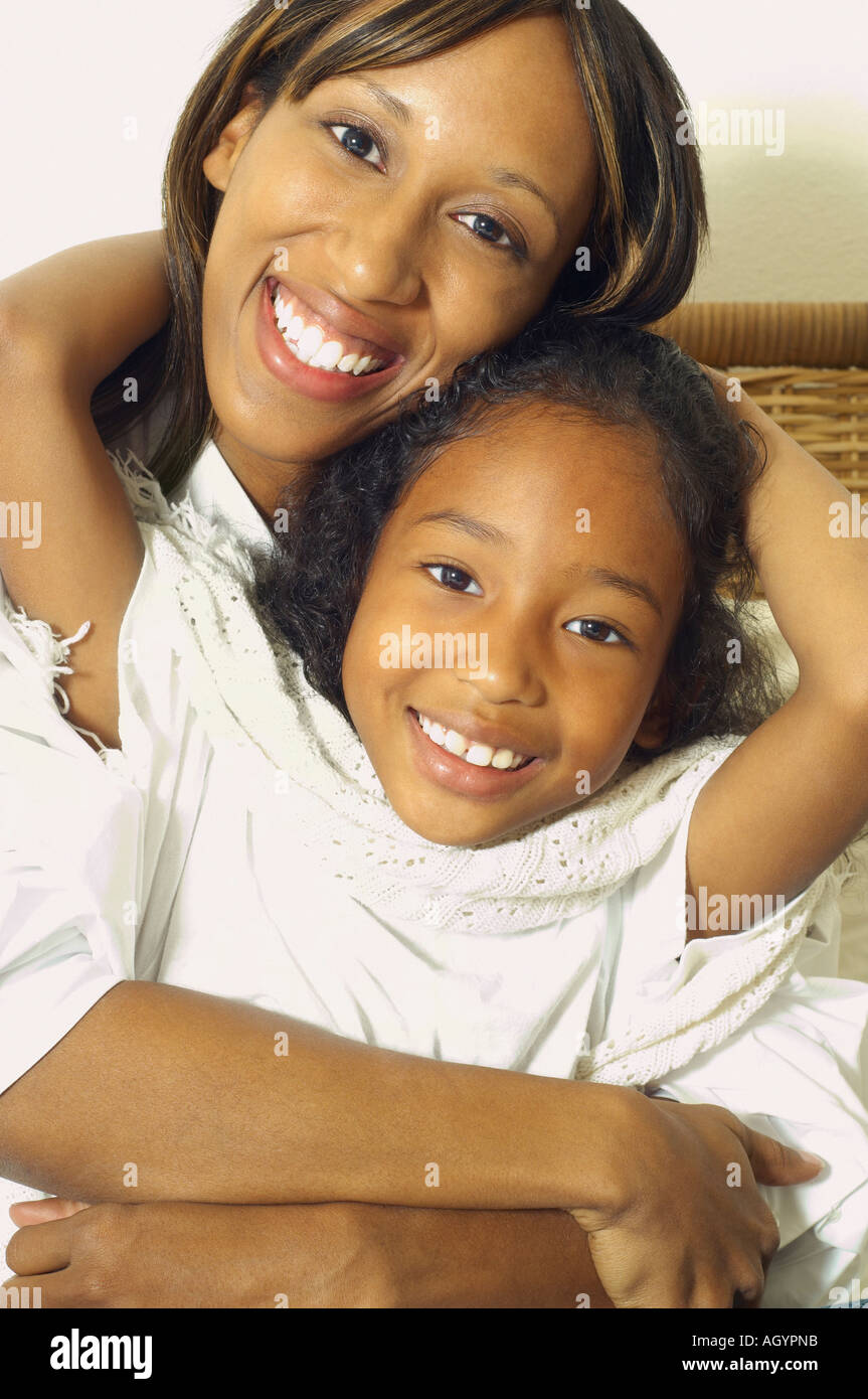 African American mother and daughter hugging Stock Photo - Alamy