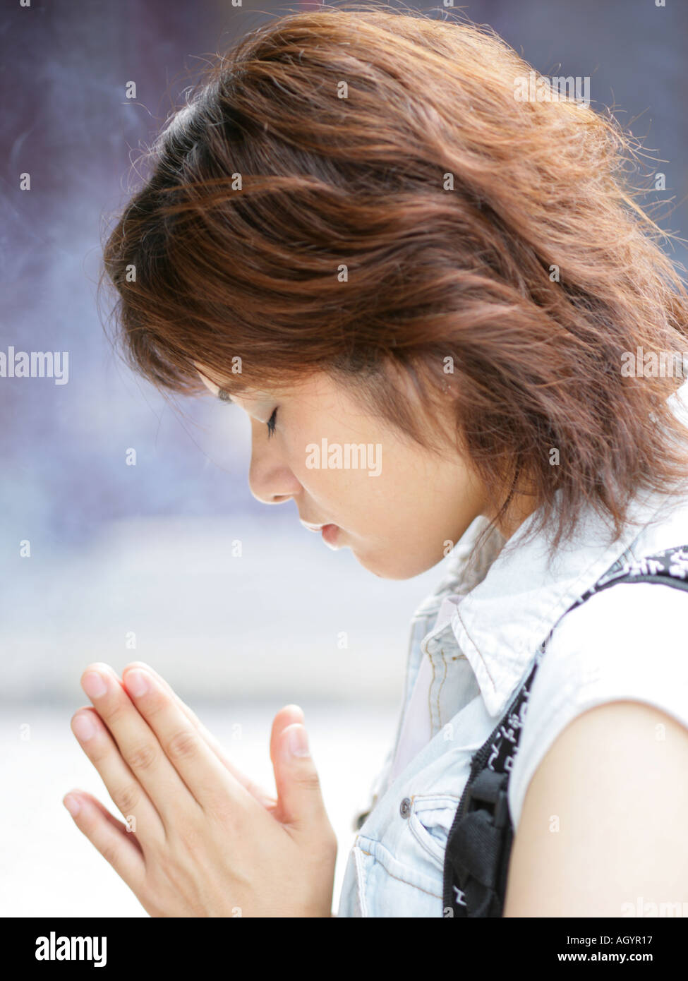 Side profile of a young woman praying Stock Photo - Alamy